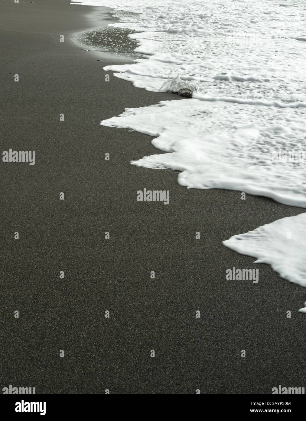 Wave rolls onto beach hi-res stock photography and images - Alamy