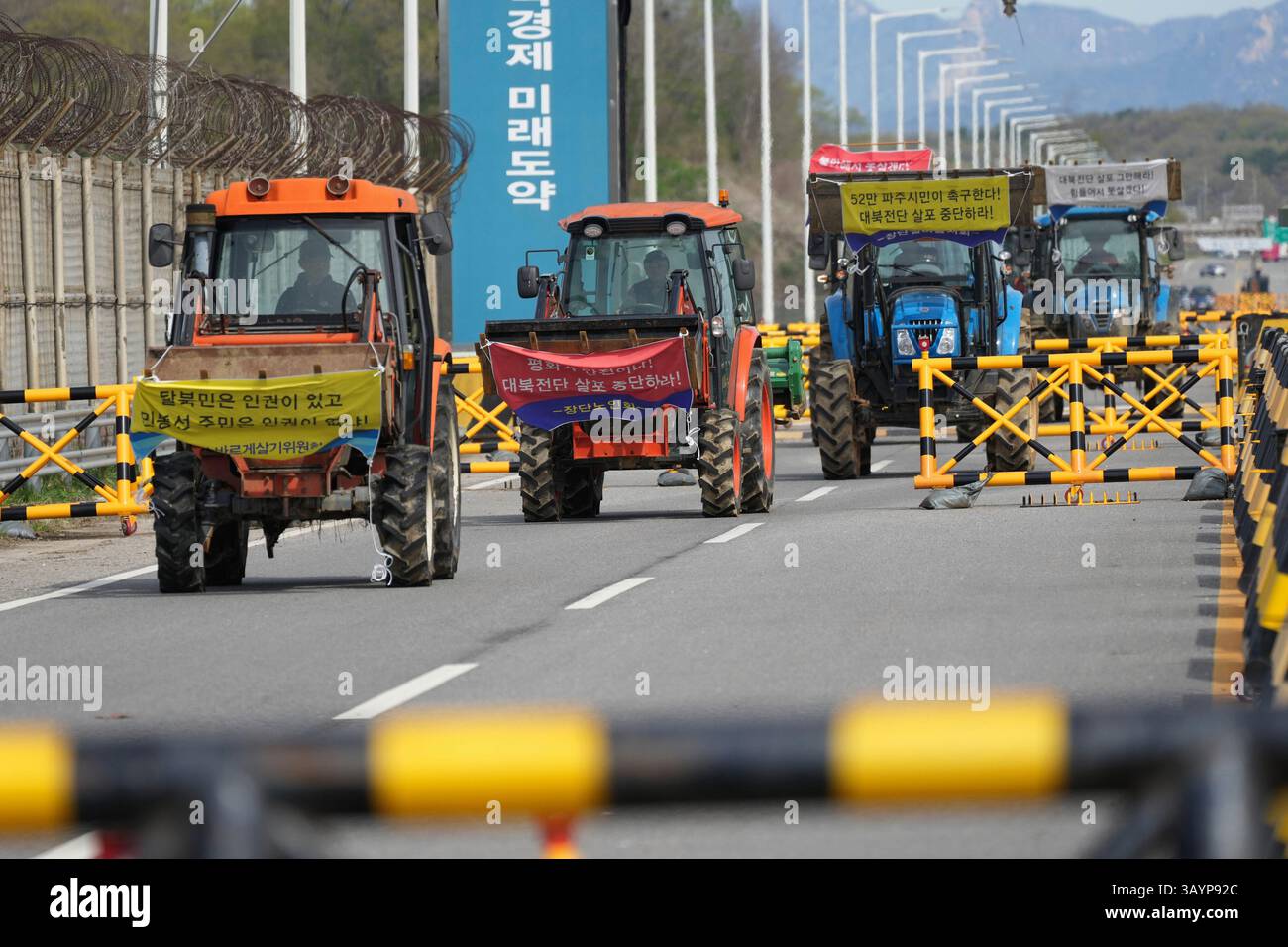 Farmers who live inside the demilitarized zone cross the Unification ...