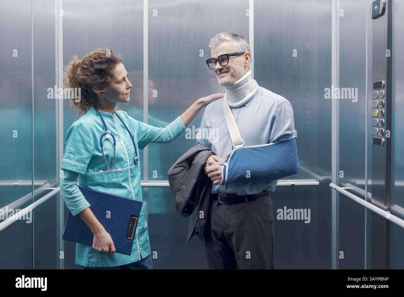 Female doctor comforting an injured patient with broken arm in the ...