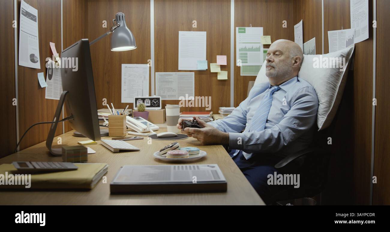 Unproductive lazy businessman playing video games instead of working ...