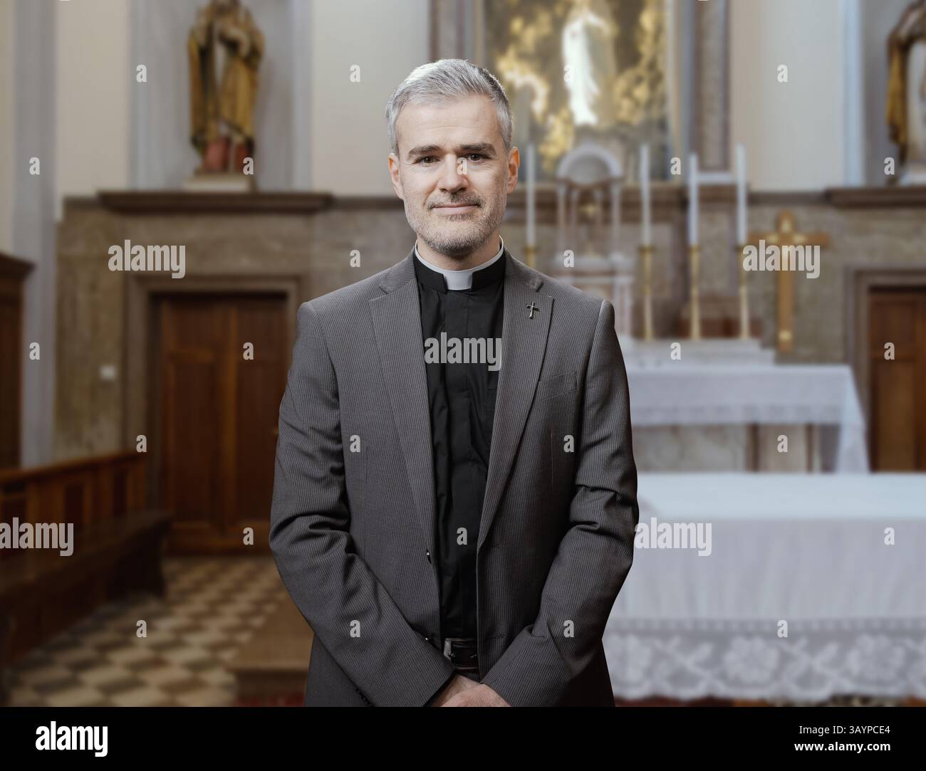 Portrait of a confident middleaged priest, dressed in clerical attire ...