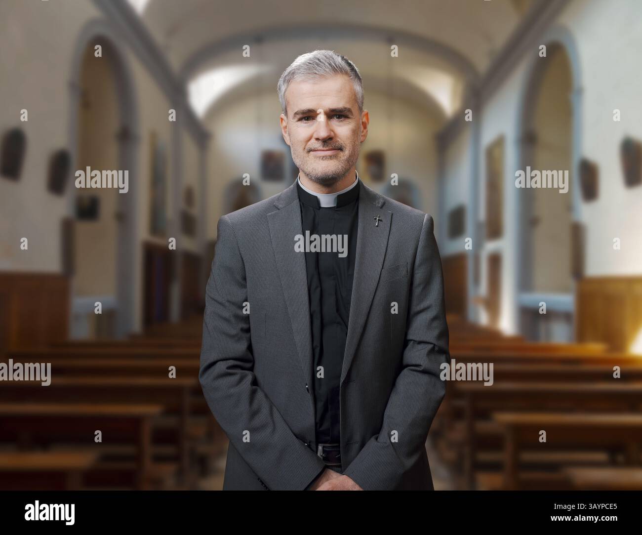 Portrait of a confident middleaged priest, dressed in clerical attire ...