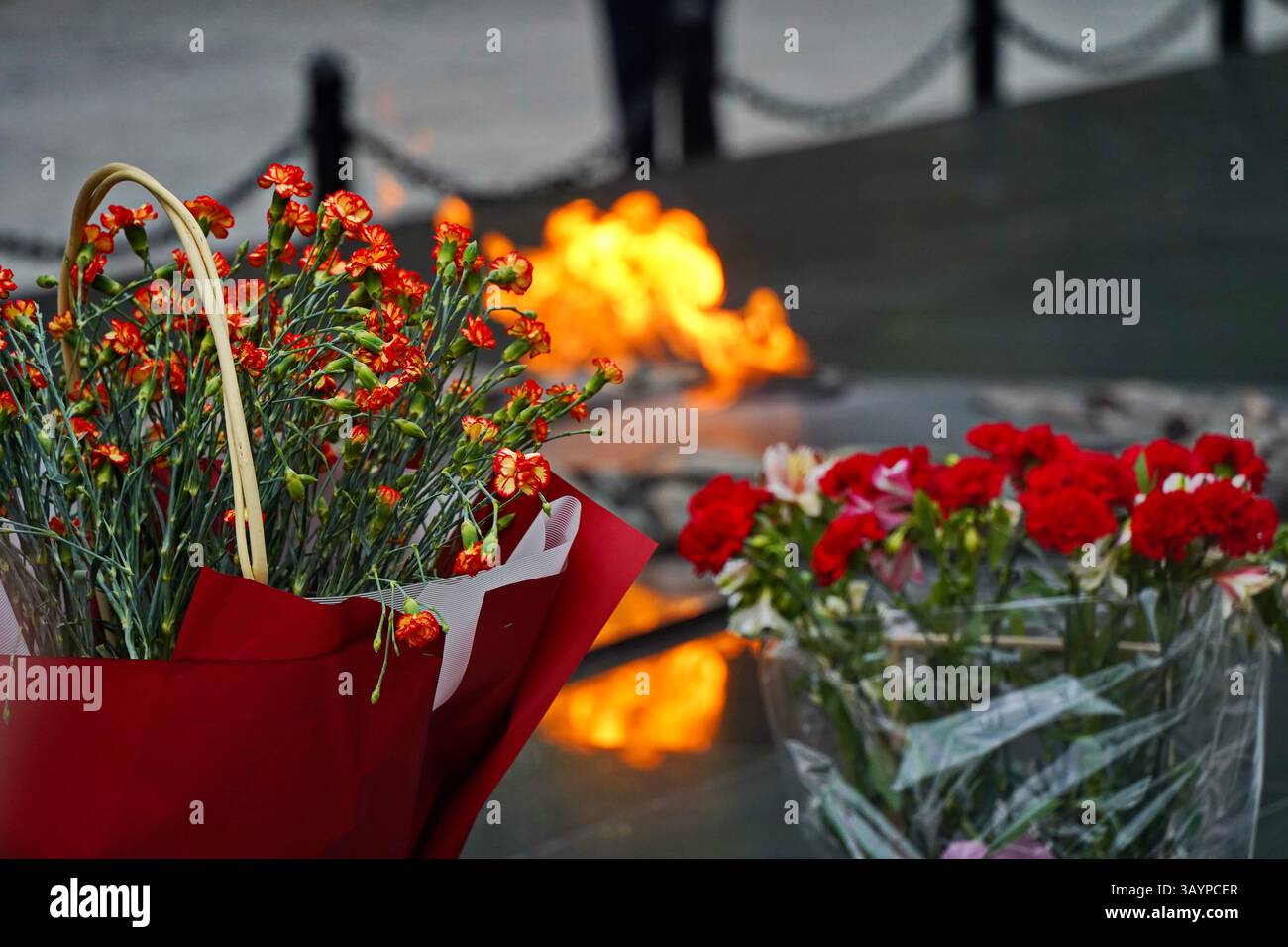 Flowers on the background of eternal flame. Memorial Day, May 9th Stock ...