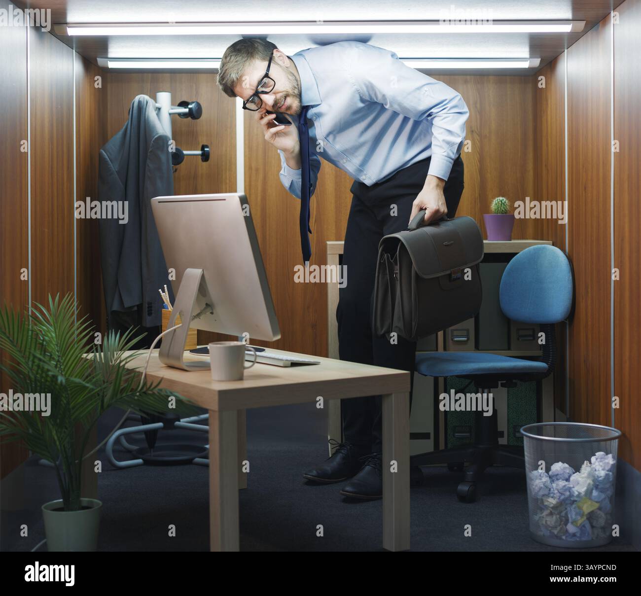 Funny corporate businessman working in a small office, he can't stand ...