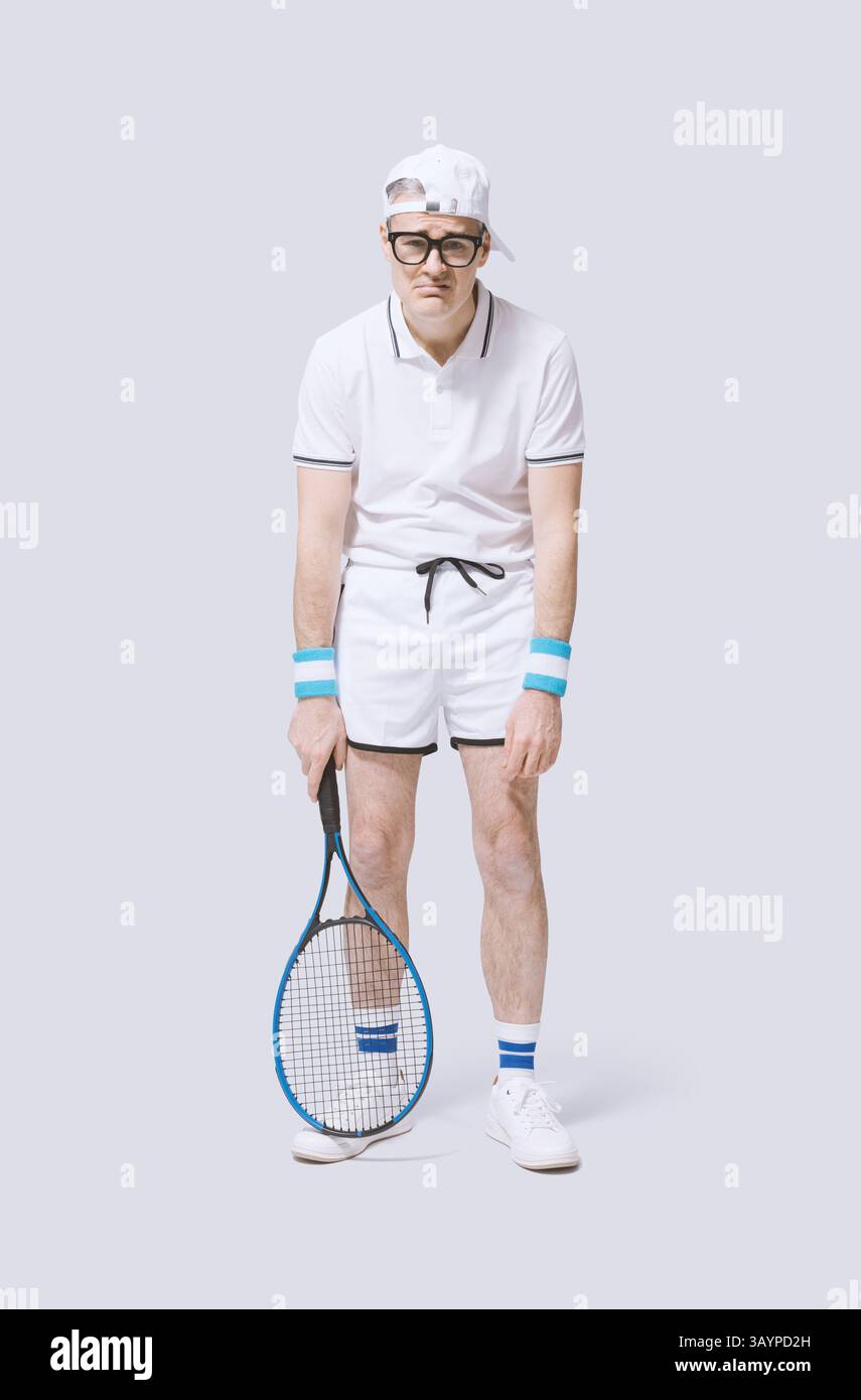 Sad frustrated tennis player after losing a tennis match, full length ...