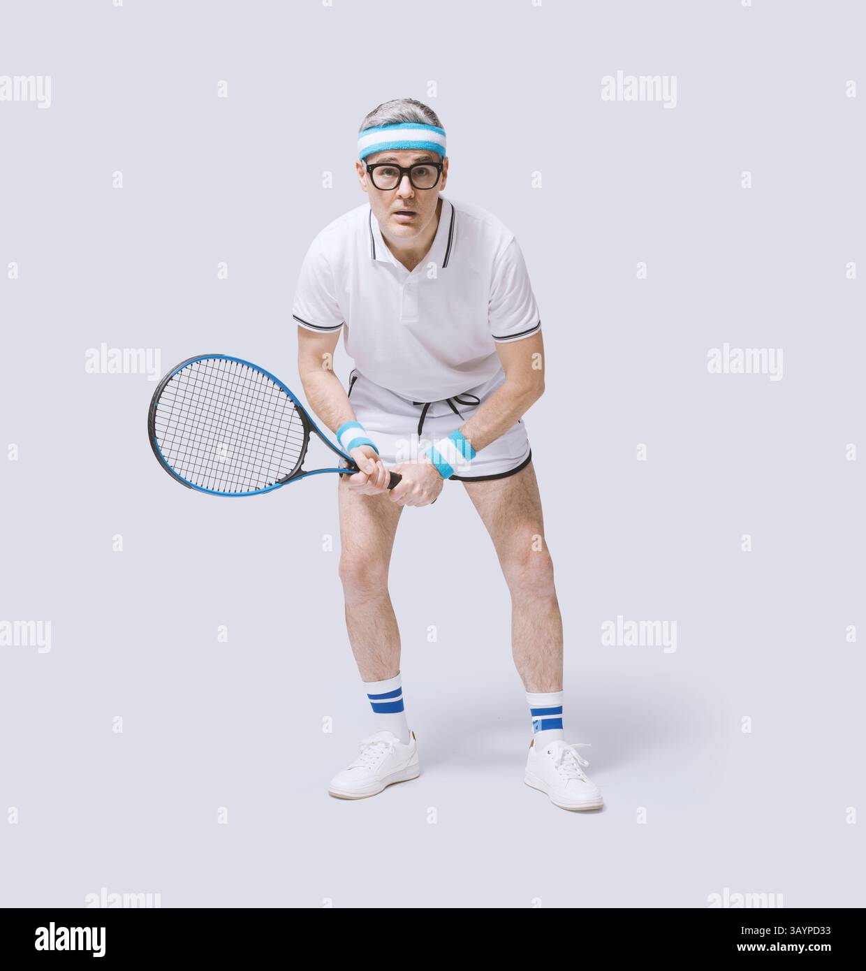 Focused amateur tennis player holding the racket and waiting for the ...