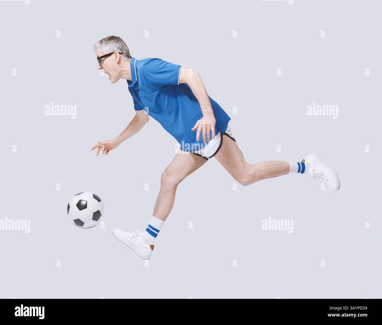 Funny clumsy soccer player kicking the ball side view, full length ...