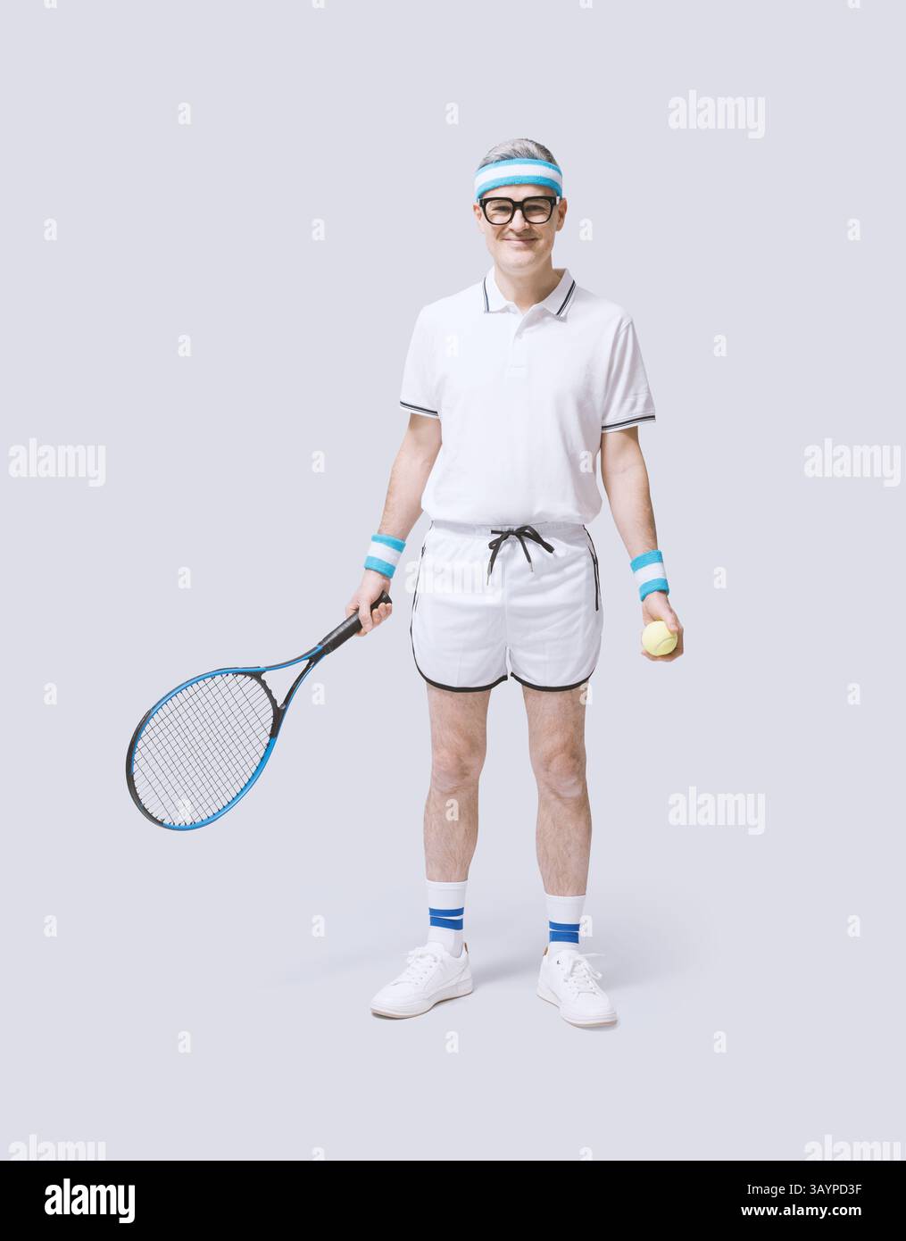 Funny tennis player posing on white background and smiling at camera ...