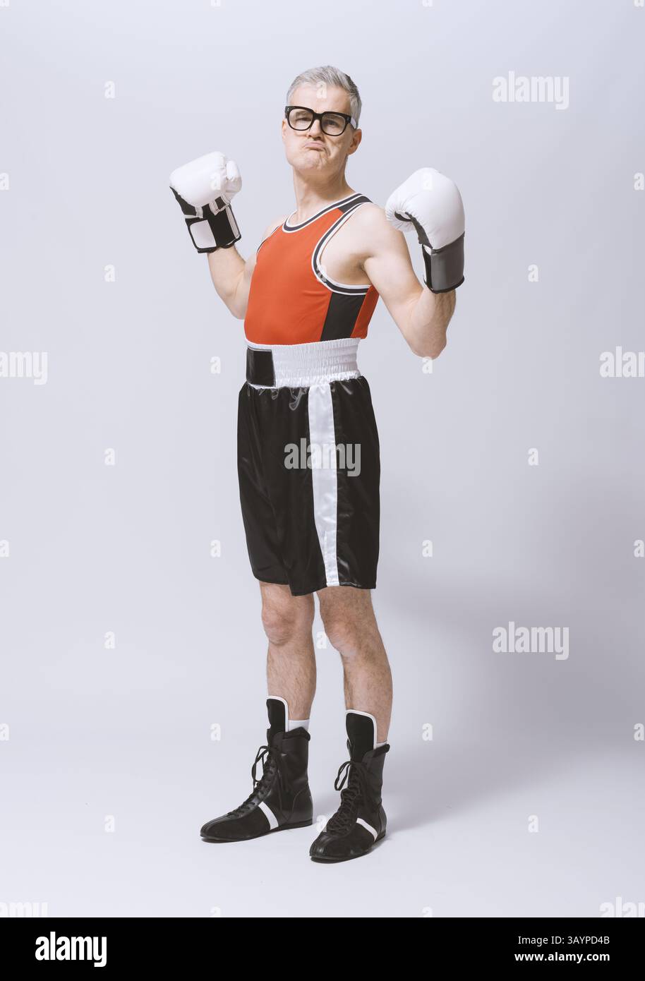 Funny aggressive skinny boxer showing off his muscles and looking at ...