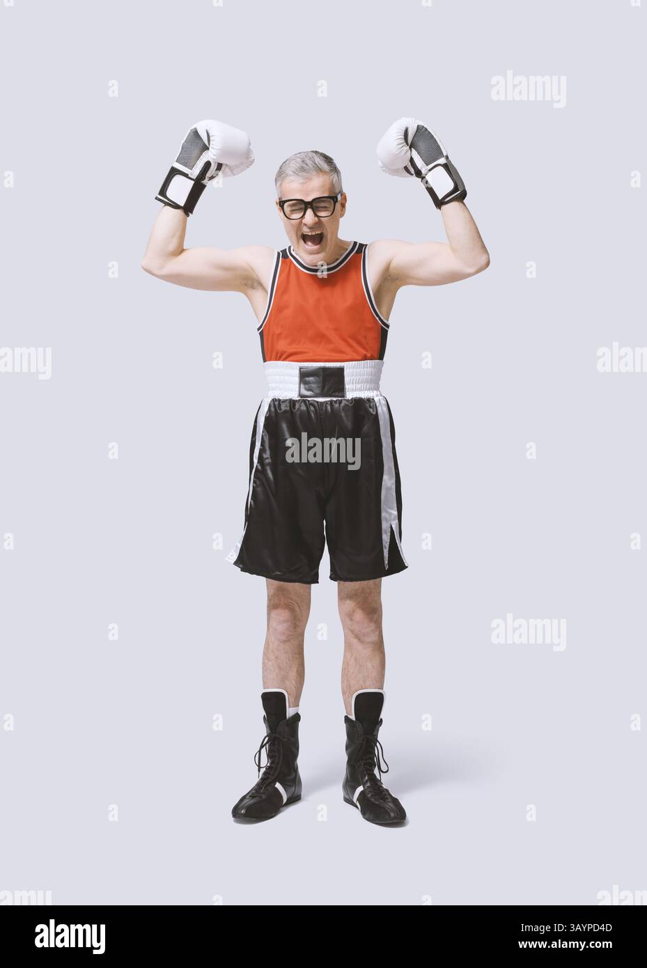 Funny aggressive skinny boxer showing off his muscles and looking at ...