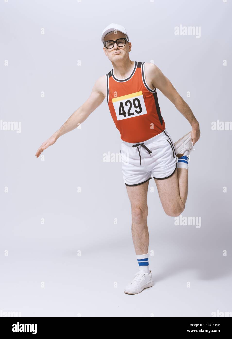 Athlete stretching his leg muscles and getting ready for the race, full ...