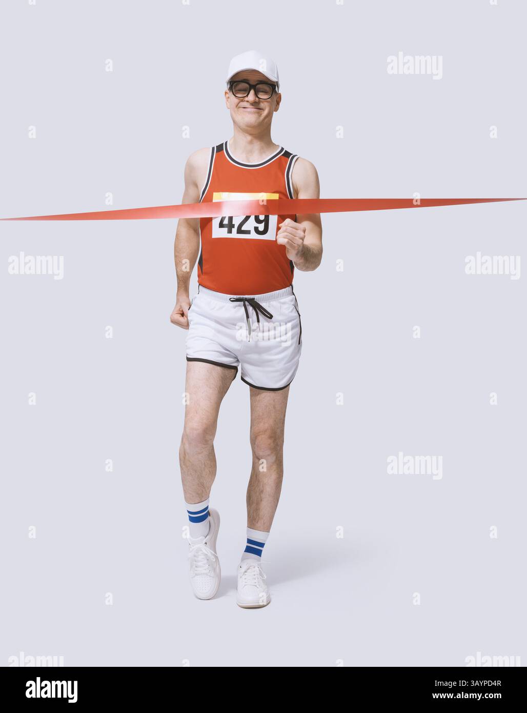 Cheerful happy runner crossing the finish line and smiling, full-length ...