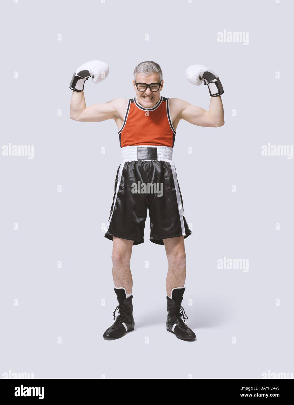 Funny aggressive skinny boxer showing off his muscles and looking at ...