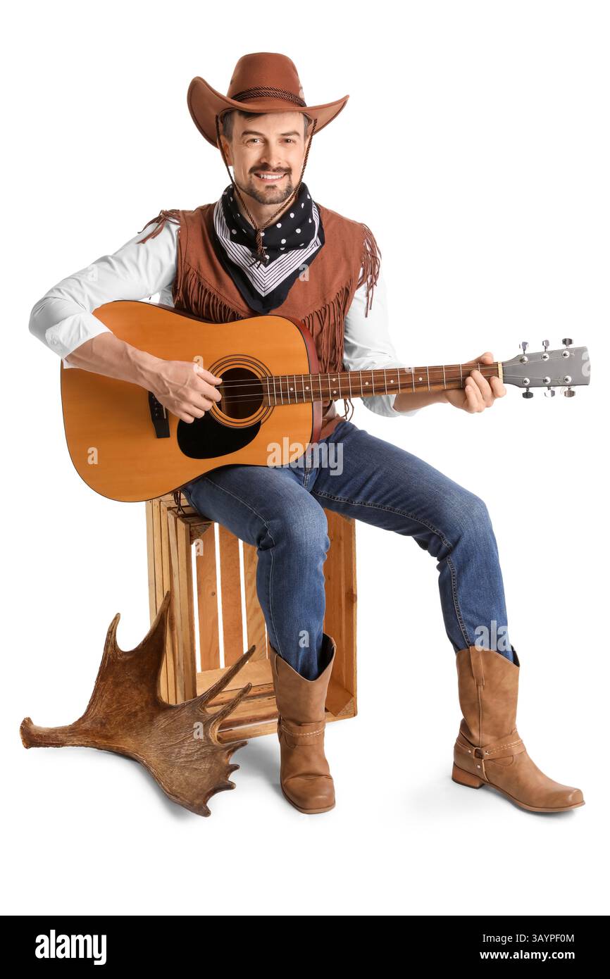 Handsome cowboy playing guitar on white background Stock Photo - Alamy