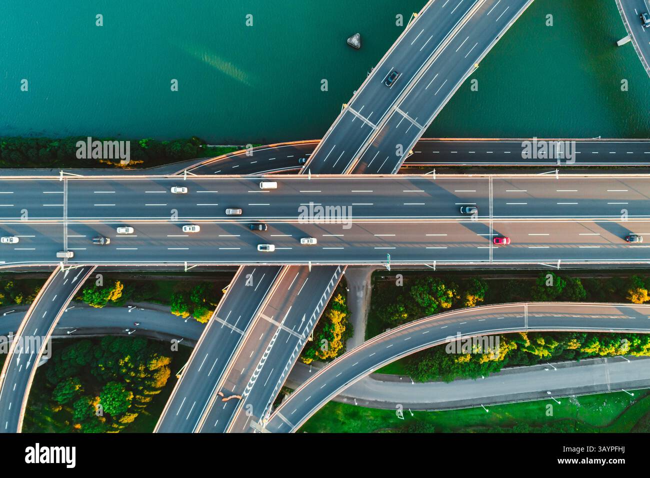 Aerial view of multiple highways intersect above a calm river ...