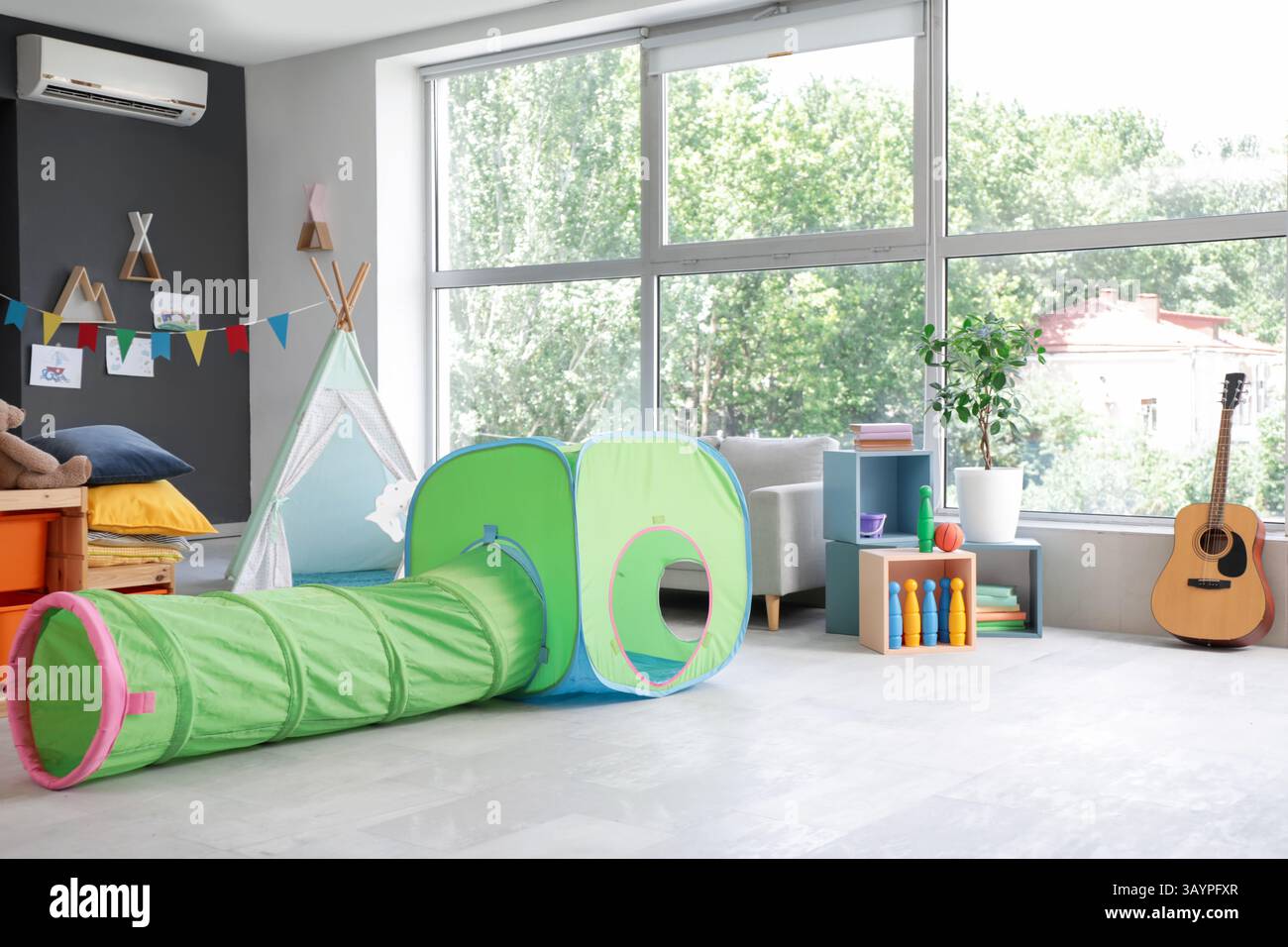 Interior of kindergarten with play tunnel and tent Stock Photo - Alamy