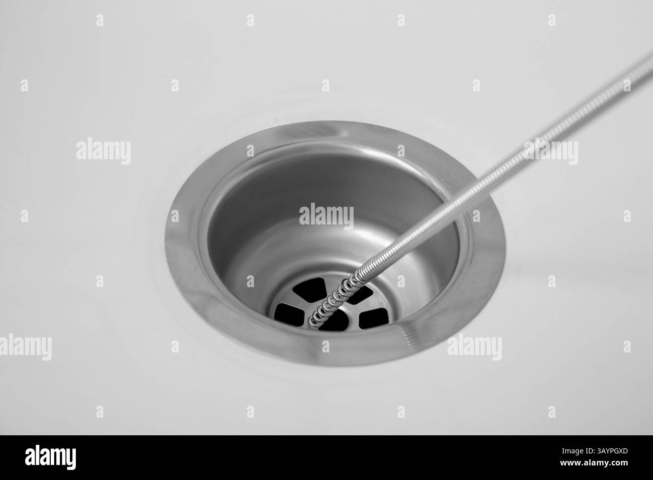 Cleaning of drain with plumber's snake, closeup Stock Photo - Alamy