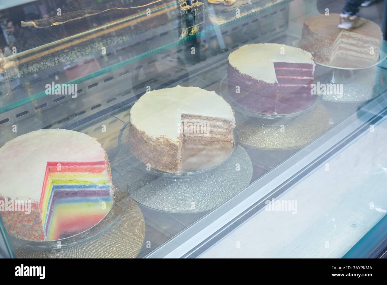 A selection of cakes stored in a cake display fridge counter at Brick ...