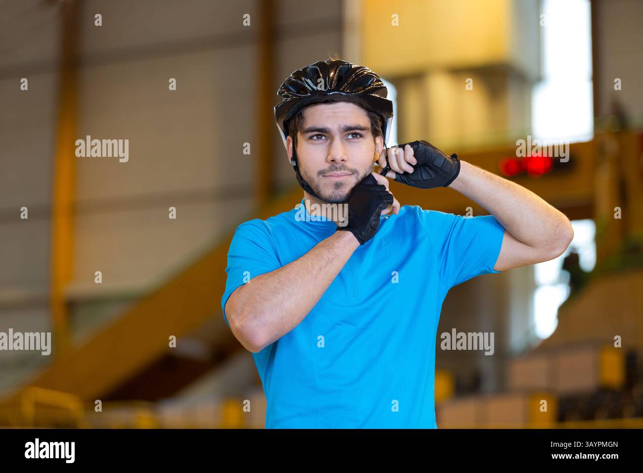 Sportsman putting on helmet hi-res stock photography and images - Alamy