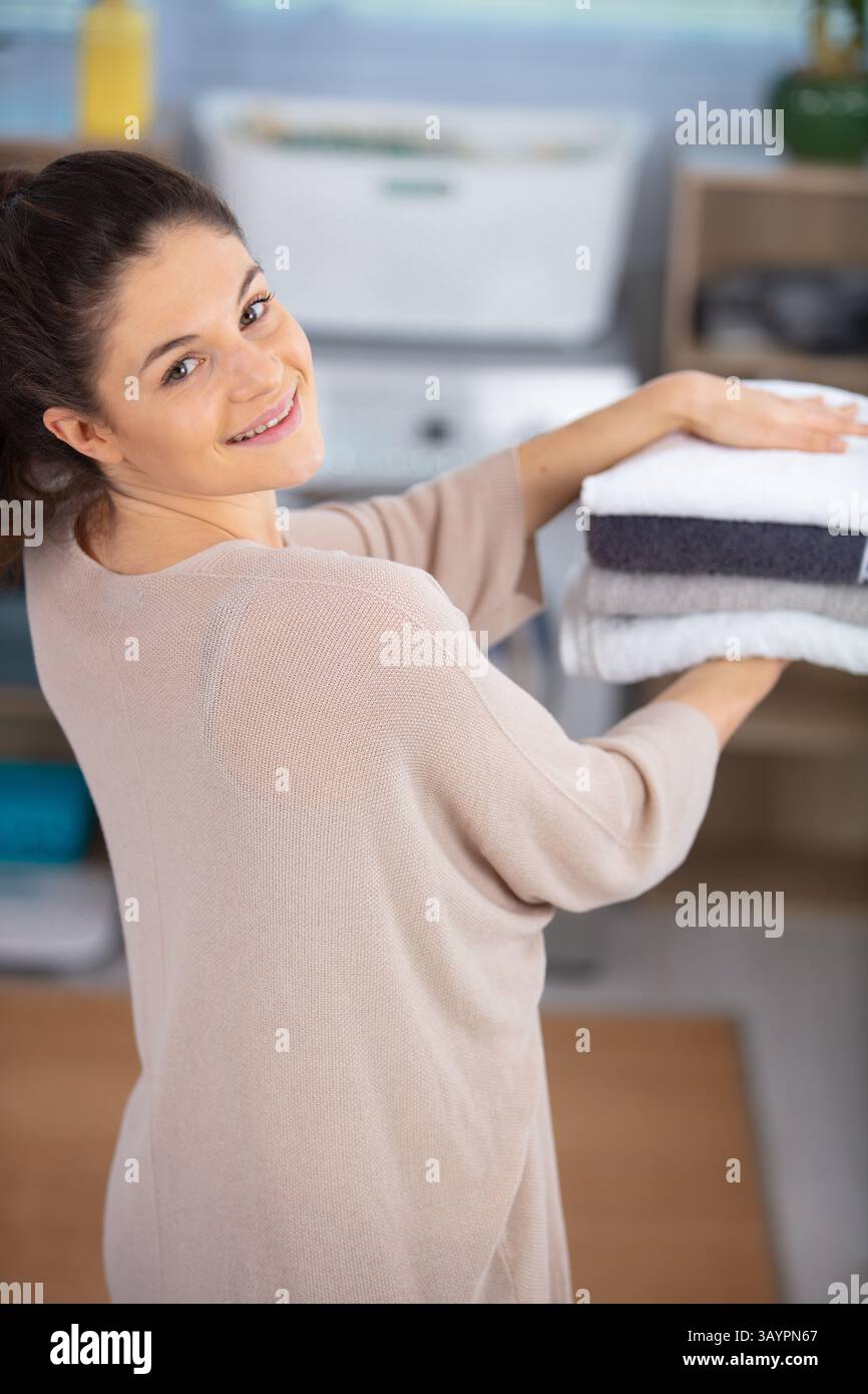 young woman holding clean laundry Stock Photo - Alamy