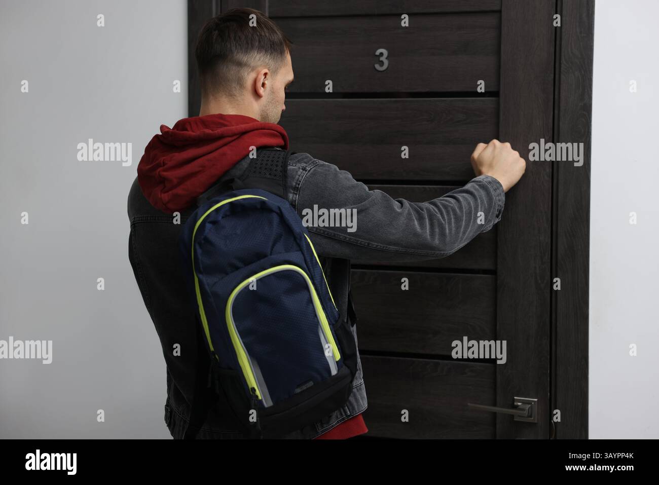 Man knocking on door of his friends apartment Stock Photo - Alamy