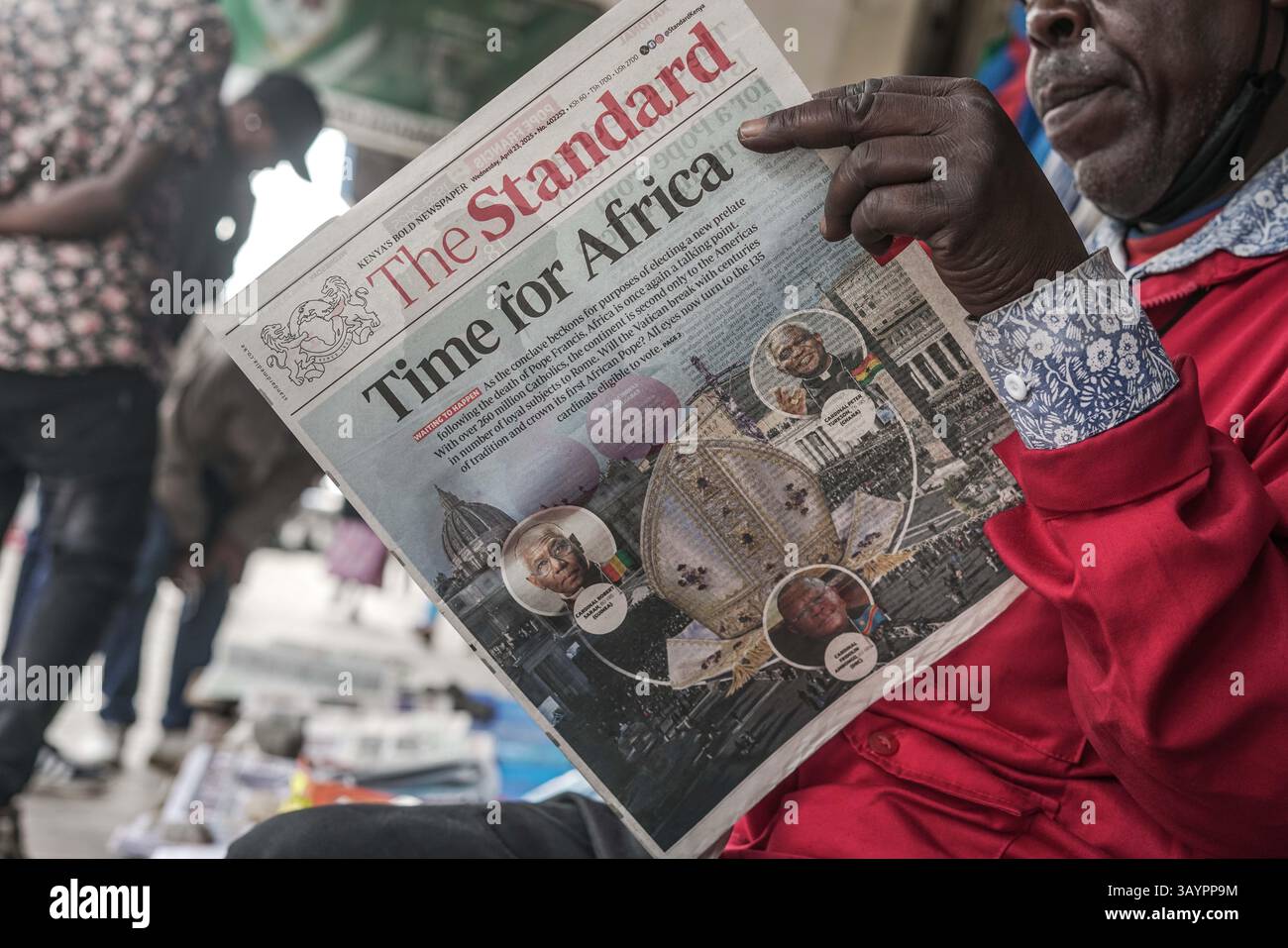 Nakuru, Kenya. 23rd Apr, 2025. A vendor reads a Kenyan newspaper, The ...