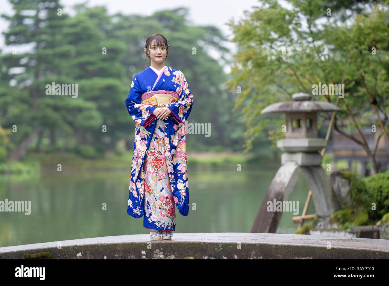 A local city in Japan on a rainy summer day. Japanese woman wearing a ...
