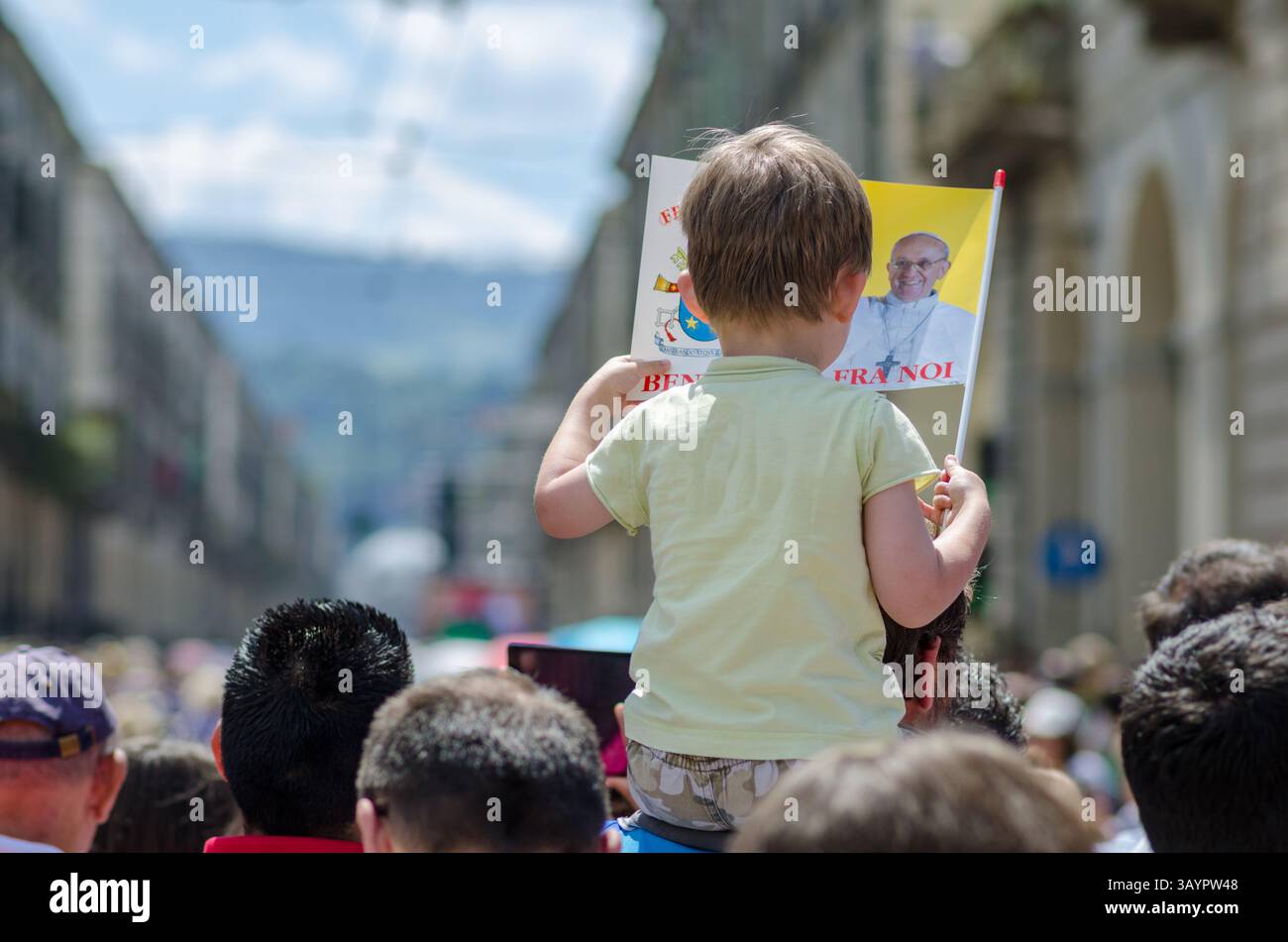 child looks at image Pope Francis, with his smile and simple and humble ...