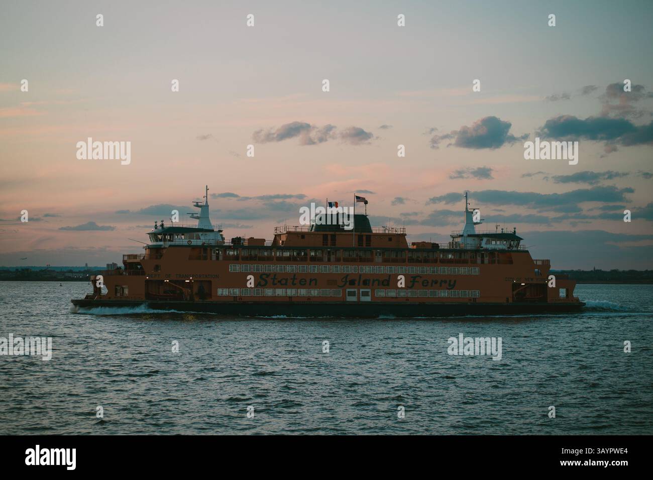 A ferry boat is currently floating peacefully on top of a body of water ...