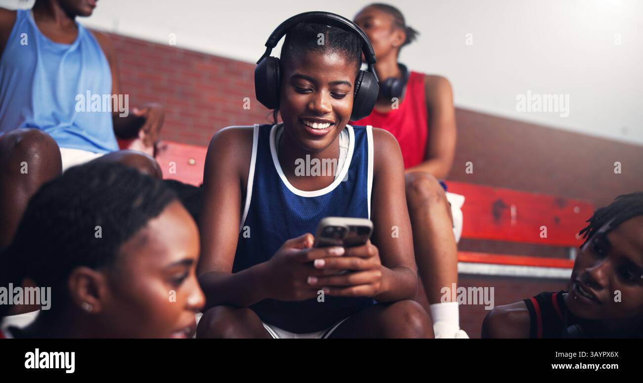 Phone, smile and headphones with black woman on basketball court for ...