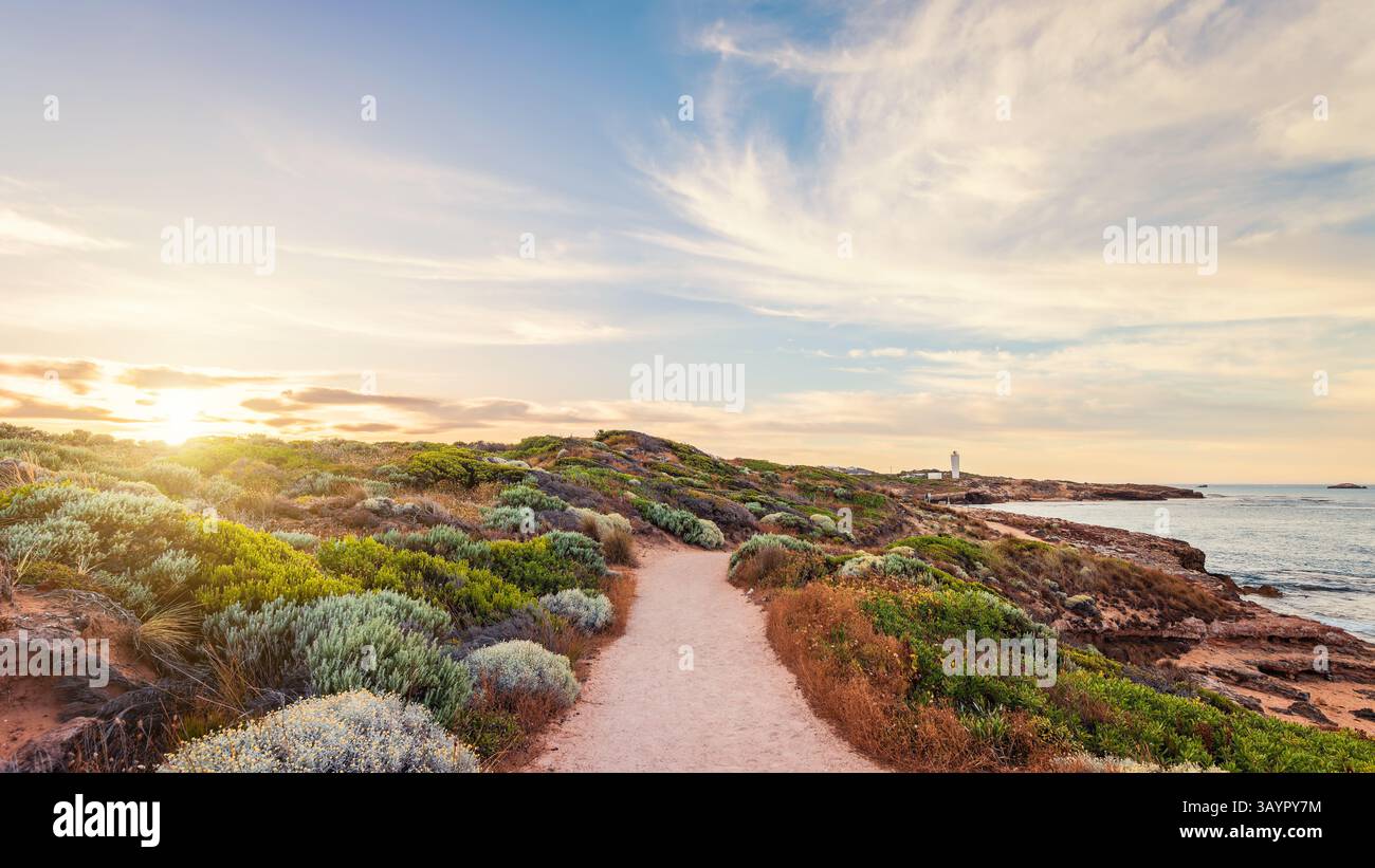 Robe Coastal Walk with lighthouse in background during sunrise ...
