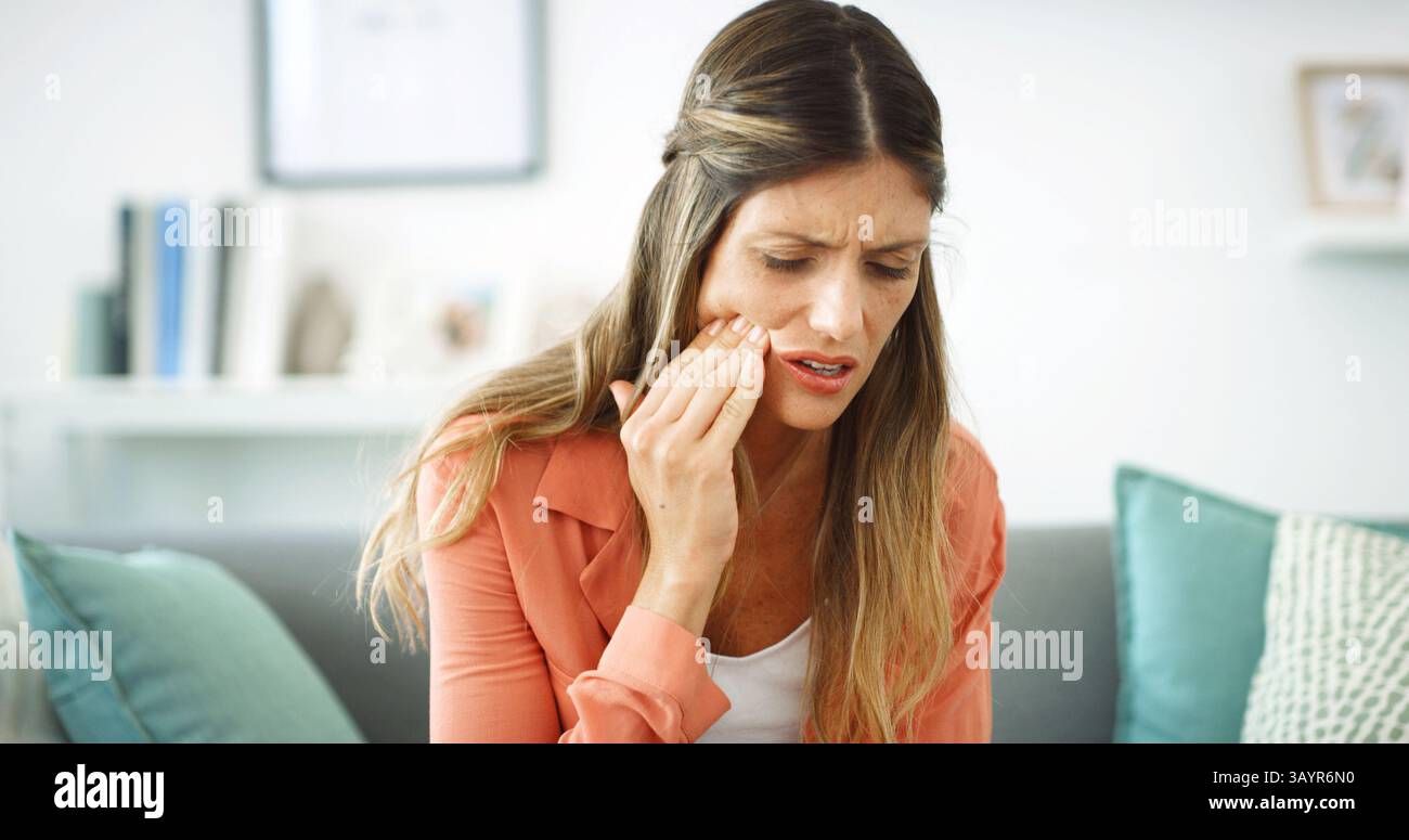 Woman, touch and cheek with toothache at house with cavity, dental ...