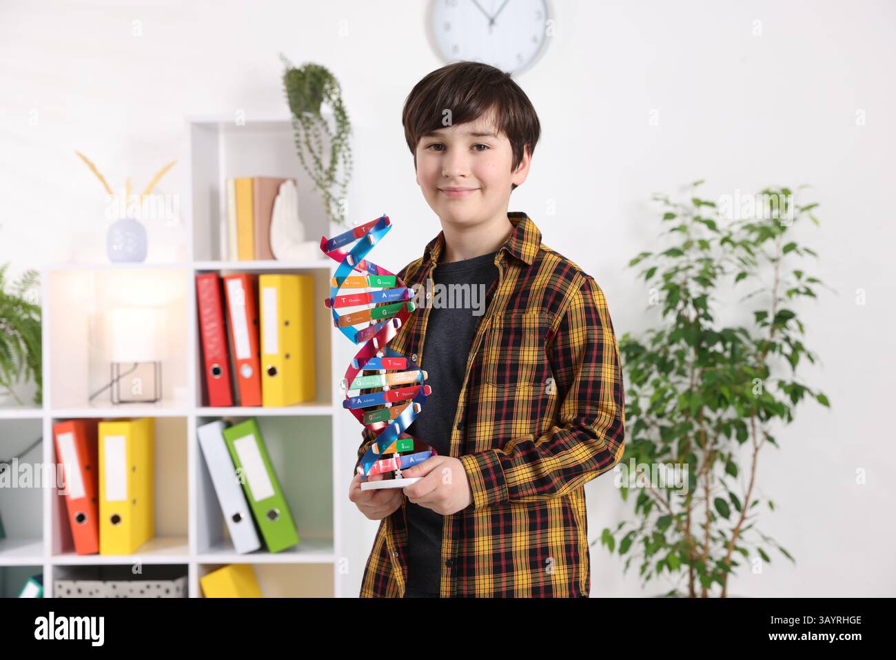 Smiling boy with DNA structure model indoors Stock Photo - Alamy