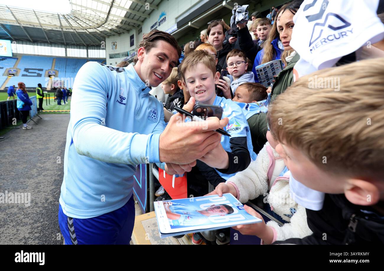 Coventry City's Luis Binks signs autographs after a training session at ...