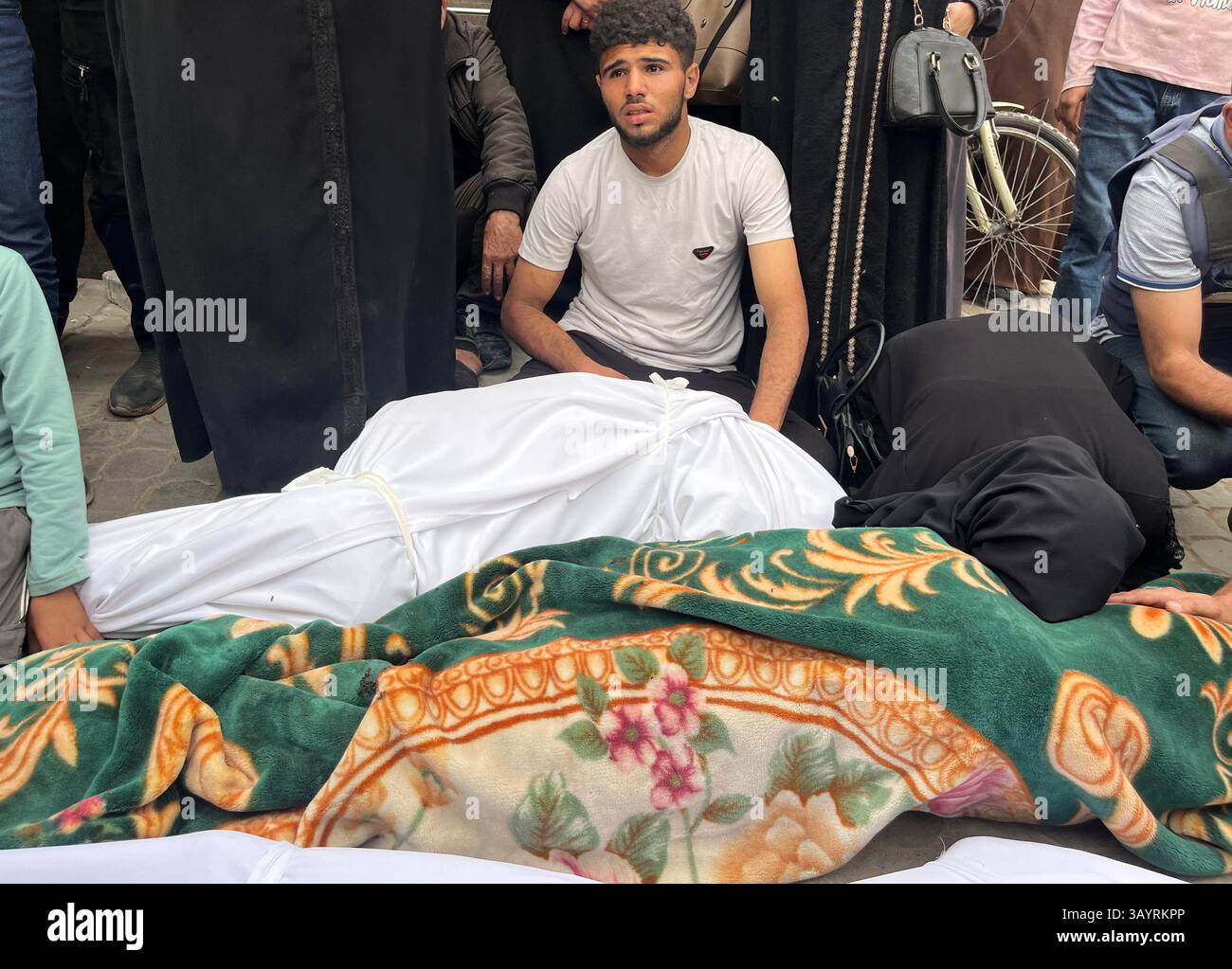 Palestinians mourn during a funeral of relatives, killed in an Israeli ...
