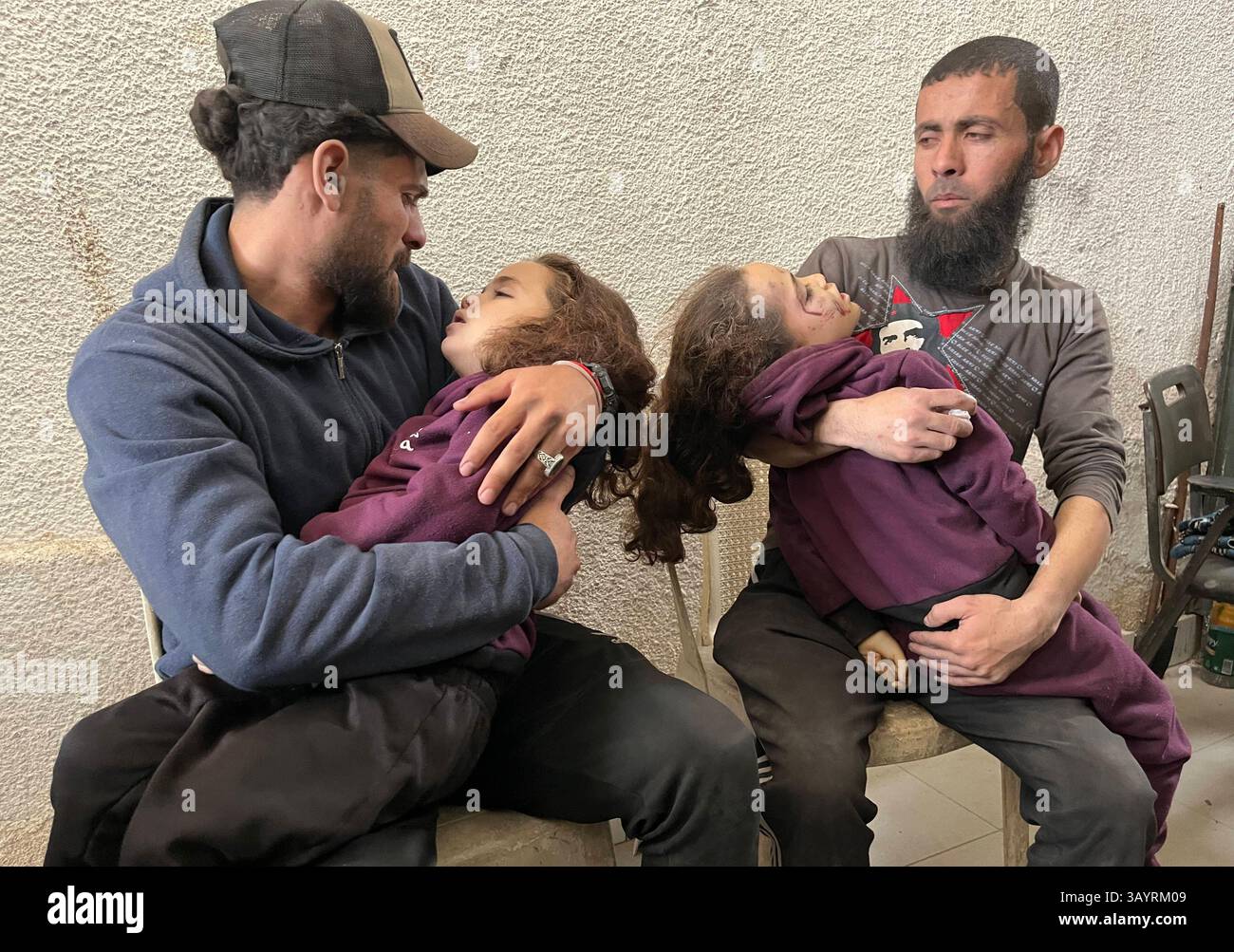 Palestinians mourn as they carry the body of twin girls from the Abu Saif family, killed in an ...