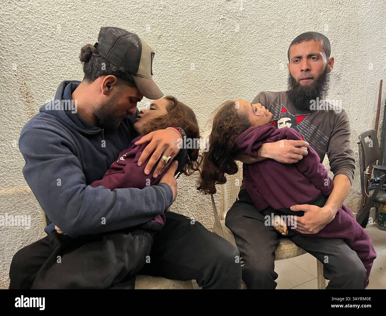 Palestinians mourn as they carry the body of twin girls from the Abu Saif family, killed in an ...