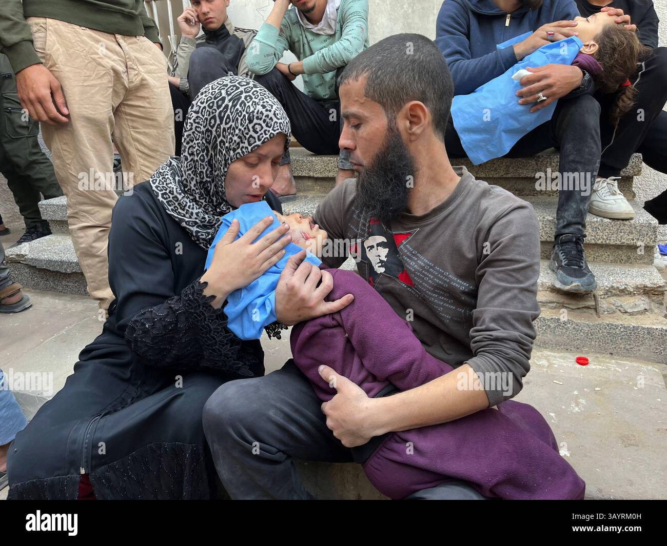 Palestinians mourn as they carry the body of twin girls from the Abu Saif family, killed in an ...