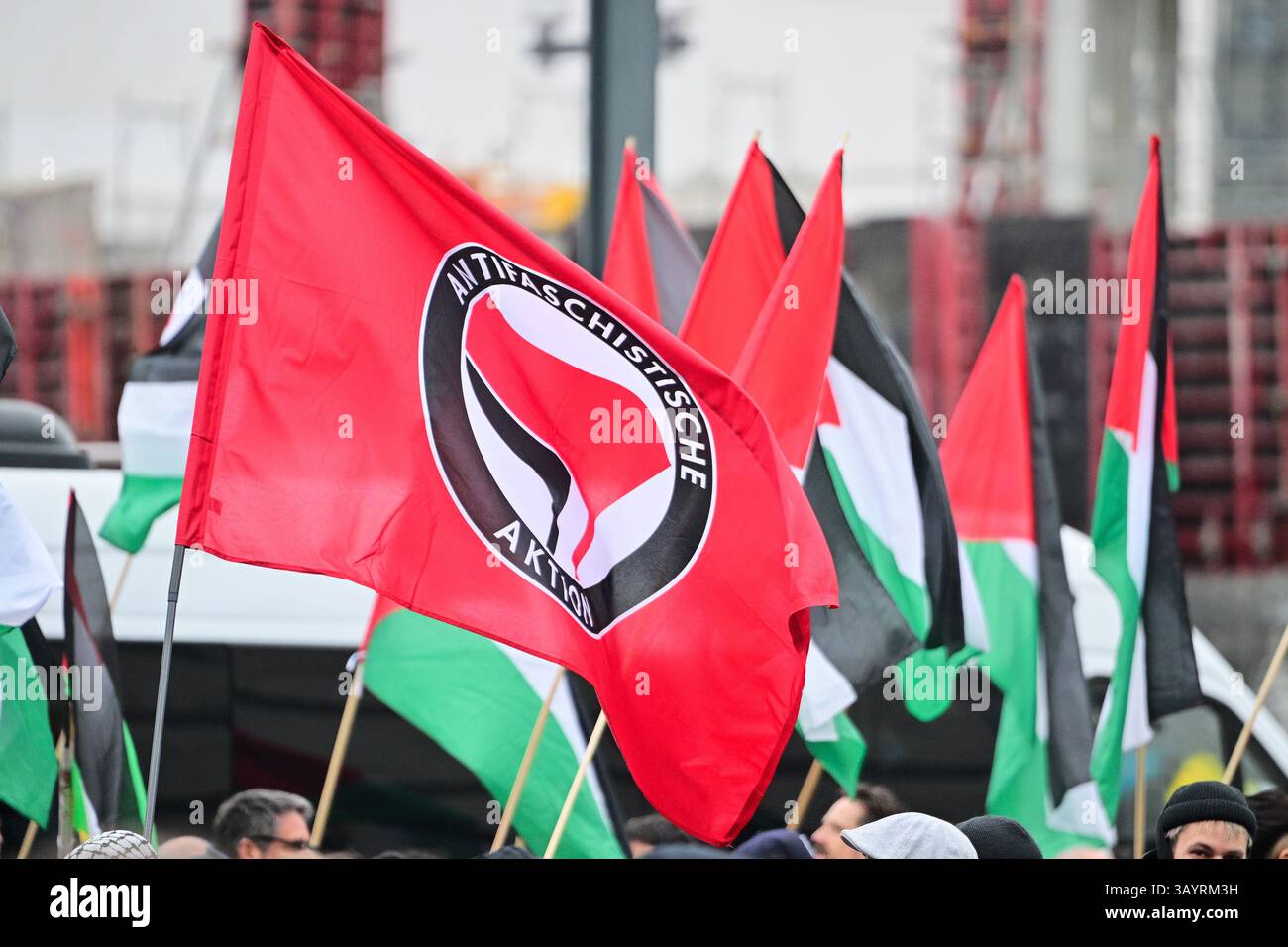 Berlin, Germany. 18th Apr, 2025. Palestinian flags are held up during a ...