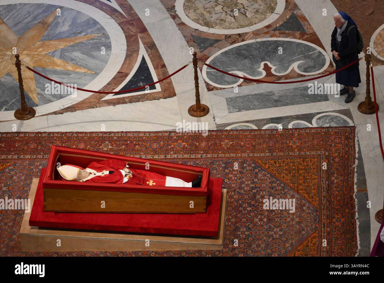 Sister Genevieve Jeanningros prays in front of the body of late Pope ...