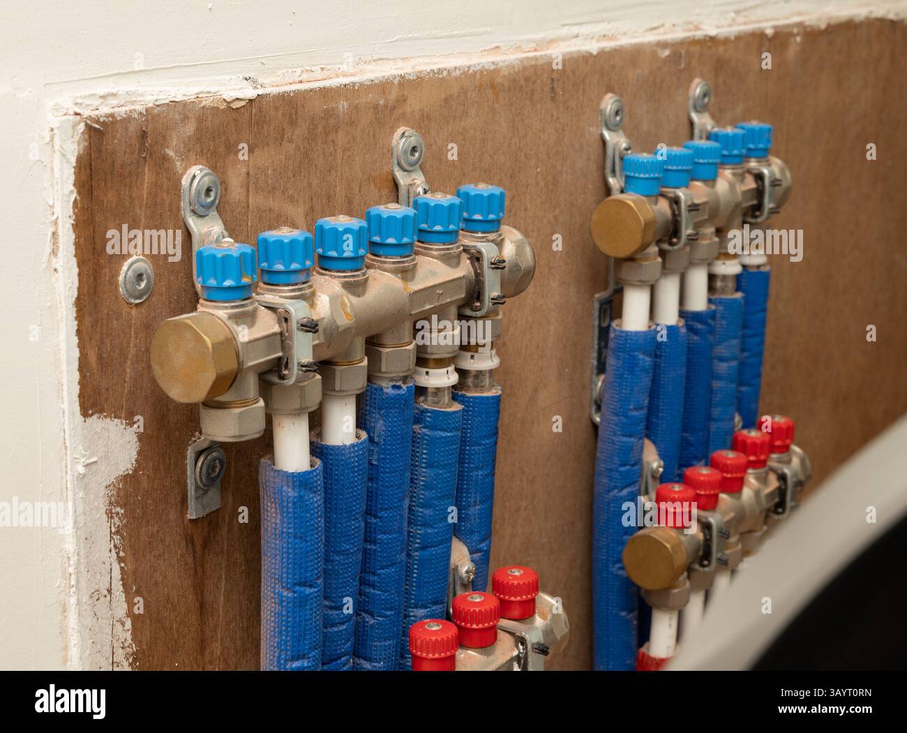 A detailed view of a complex piping system with various valves and colorful hoses for effective ...