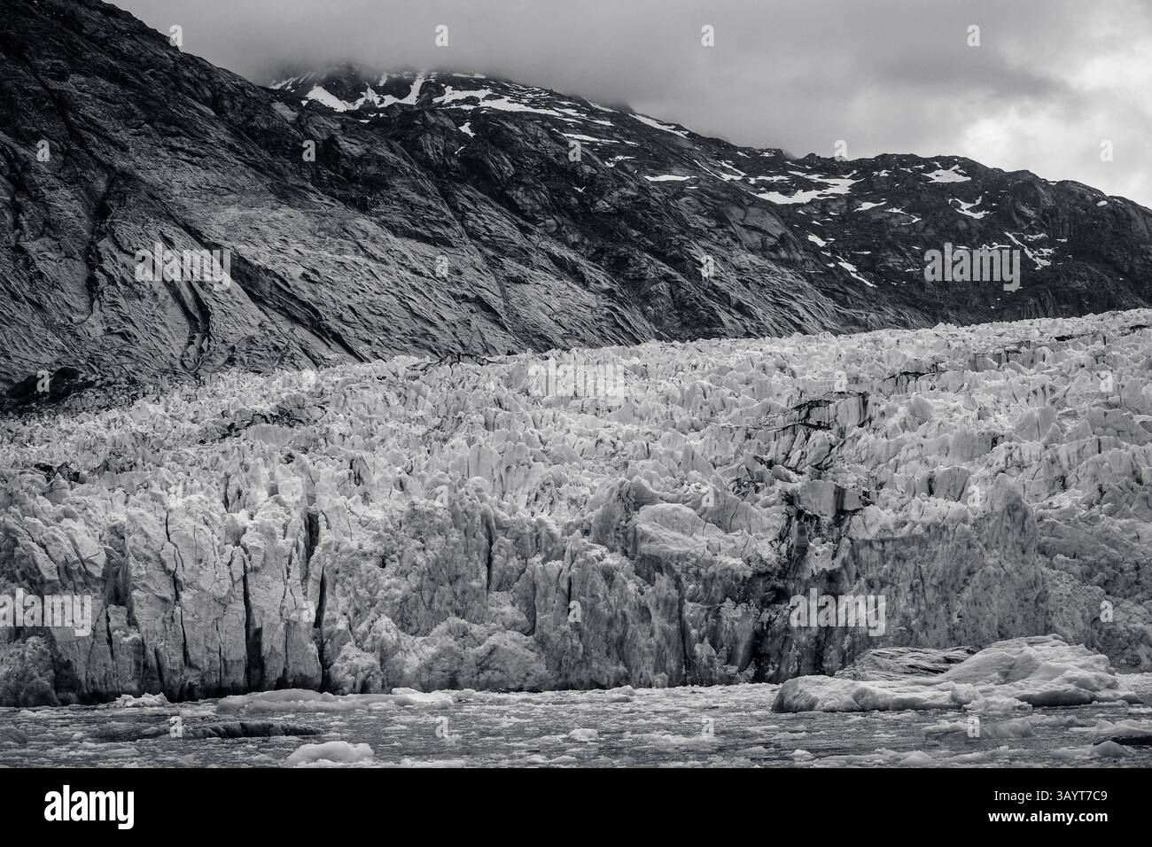 Cold sloping land and low clouds over Dawes Glacier in Alaska Stock ...