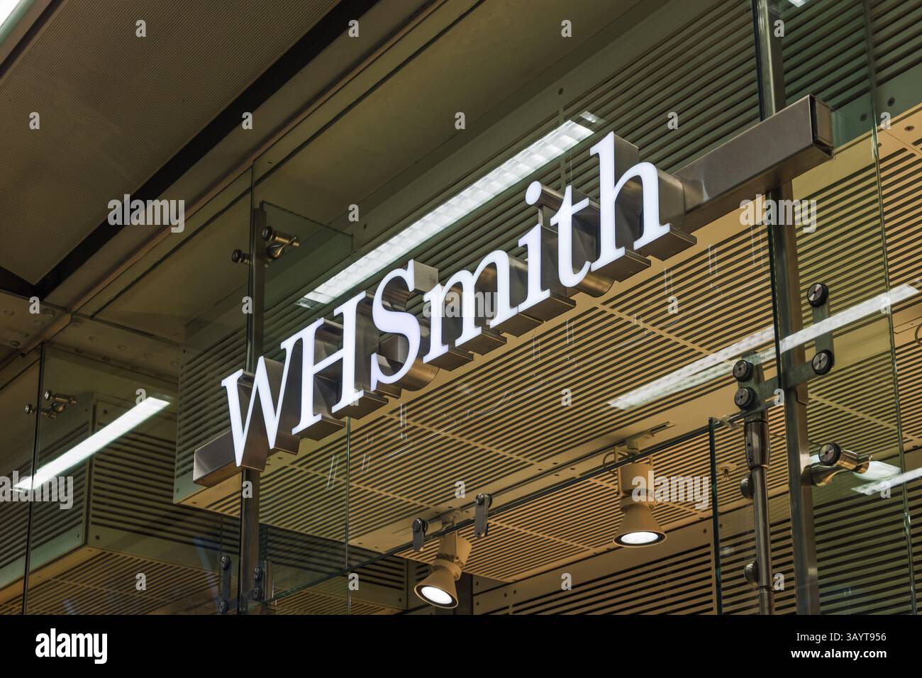 Illuminated WHSmith sign on glass storefront in a modern shopping mall ...
