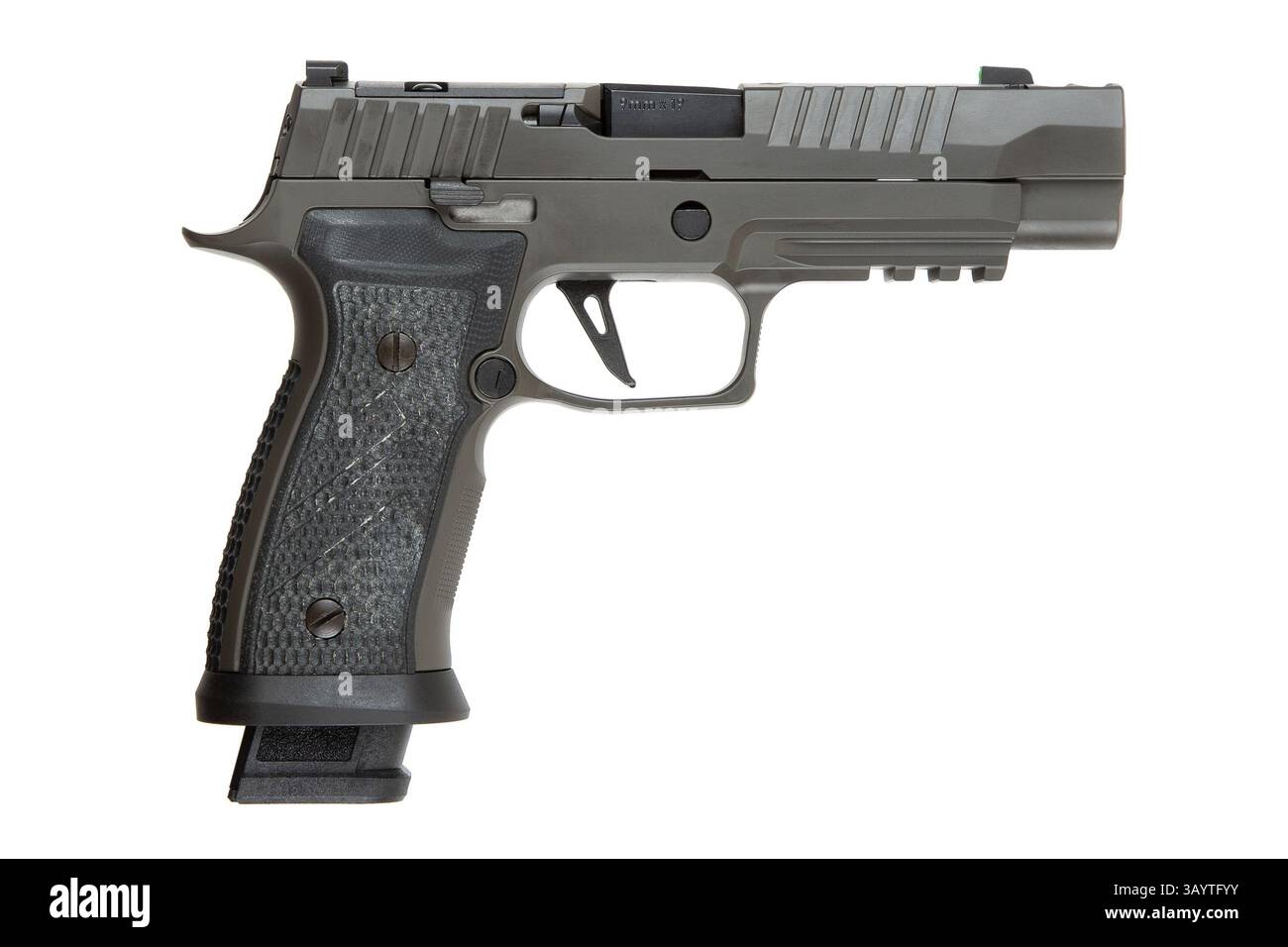 Side view of a modern tactical semi-automatic pistol with textured grip ...