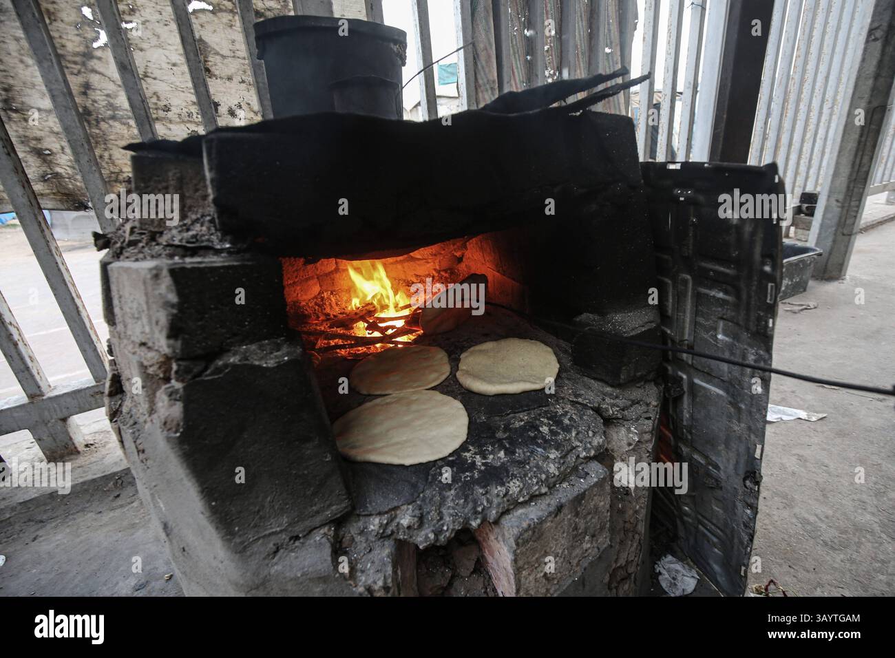 Palestinians prepare their food in wood-fired ovens as Palestinians ...