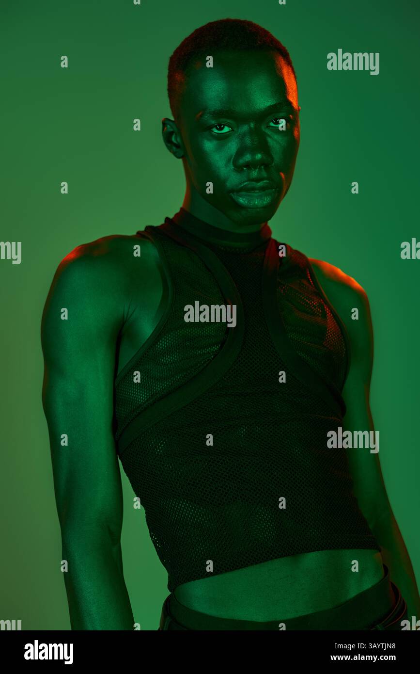 Stylish young man displays confident attitude in striking attire ...