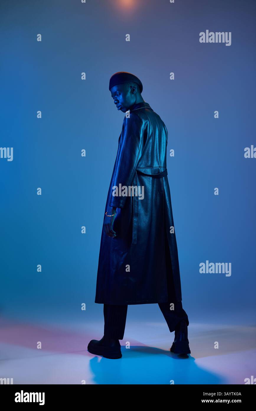 A young man flaunts his fashion sense in a striking pose against a ...