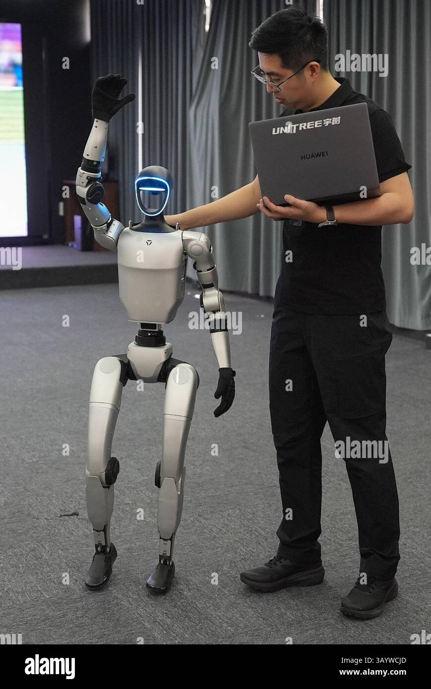 Hangzhou, China's Zhejiang Province. 23rd Apr, 2025. A Unitree G1 humanoid robot shows waves at ...