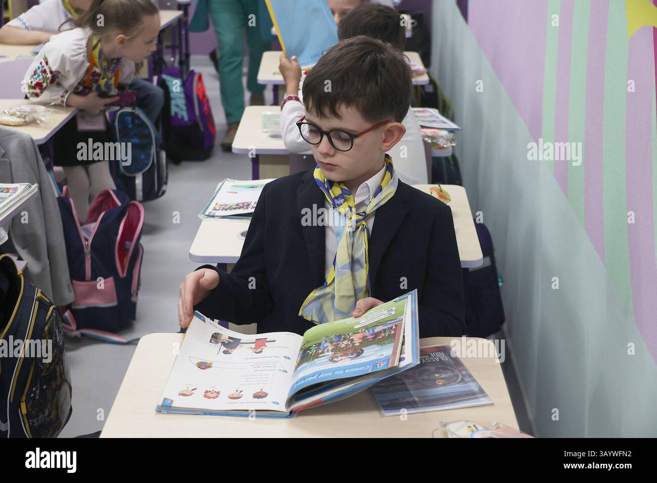Non Exclusive: A student turns pages of a textbook during a lesson in a ...