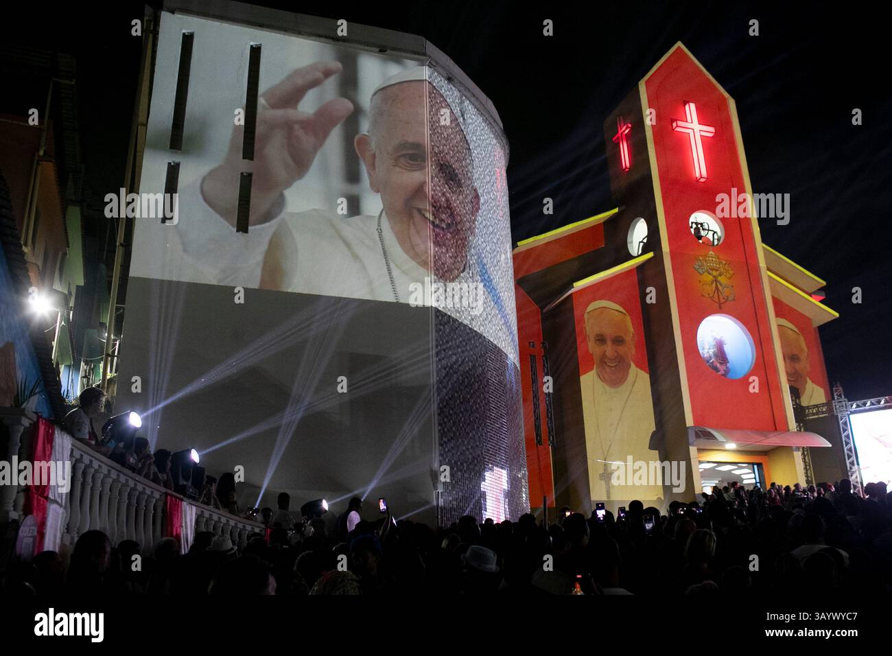 Photos of late Pope Francis are projected outside Saint George Church ...